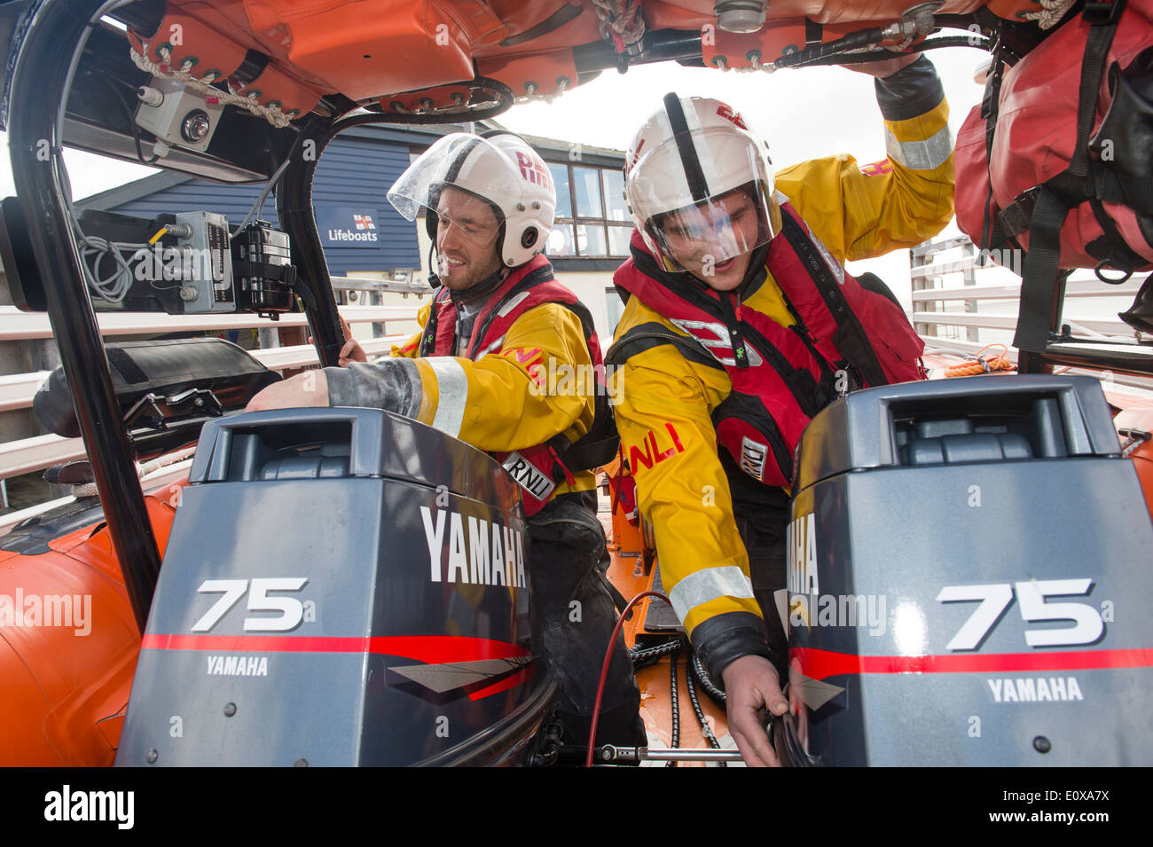 Two RNLI Royal National Lifeboat Institution volunteer crew members ...