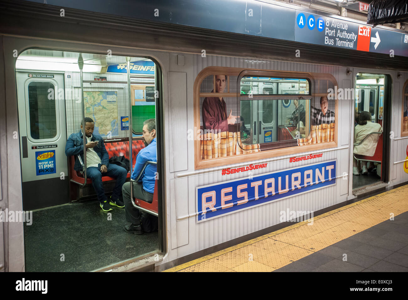 A Flushing line subway train in Times Square is wrapped in advertising ...