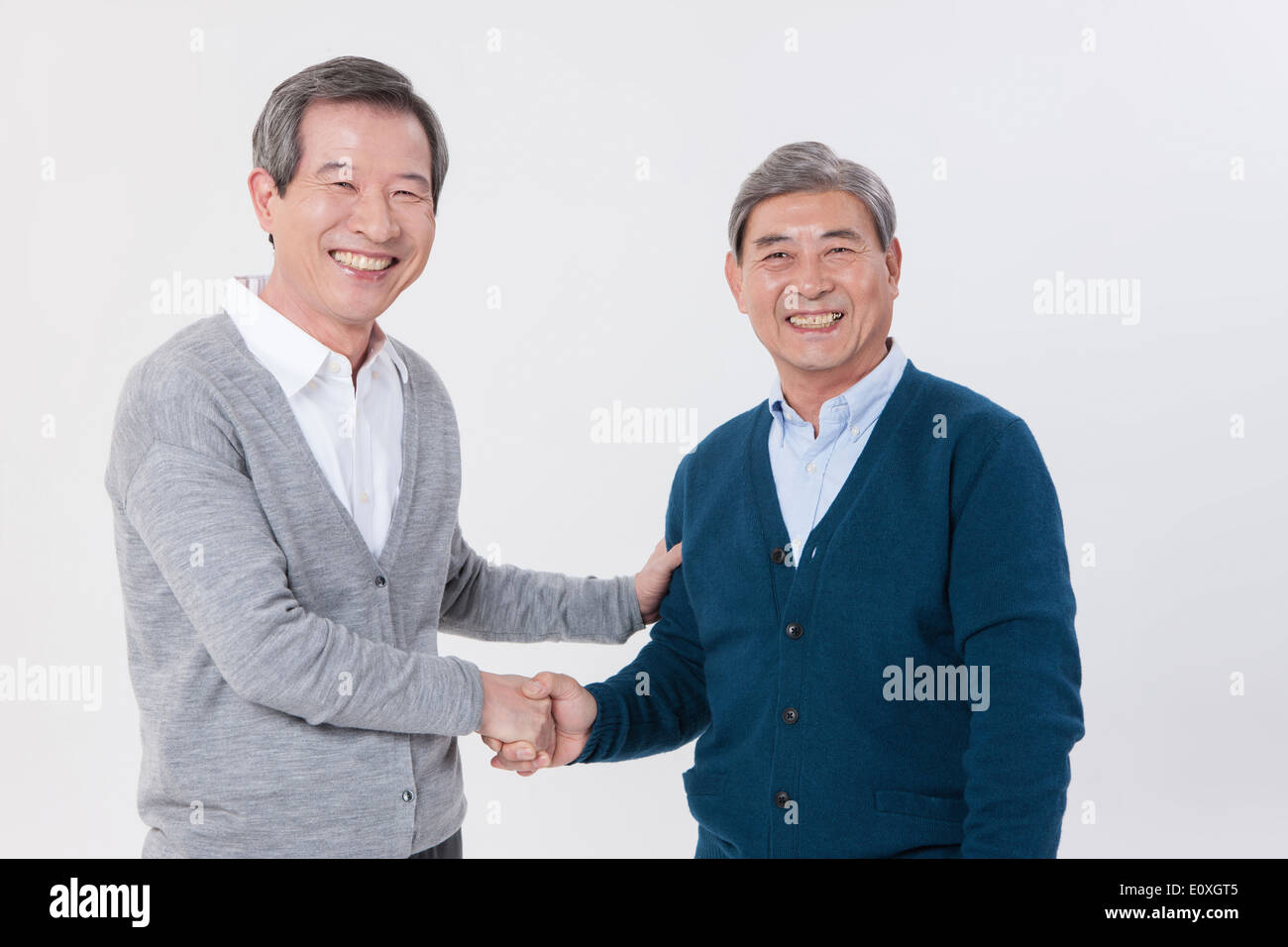 two old men shaking hands Stock Photo - Alamy