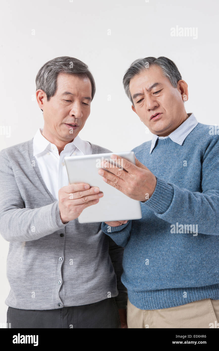 two old men using a tablet Stock Photo - Alamy
