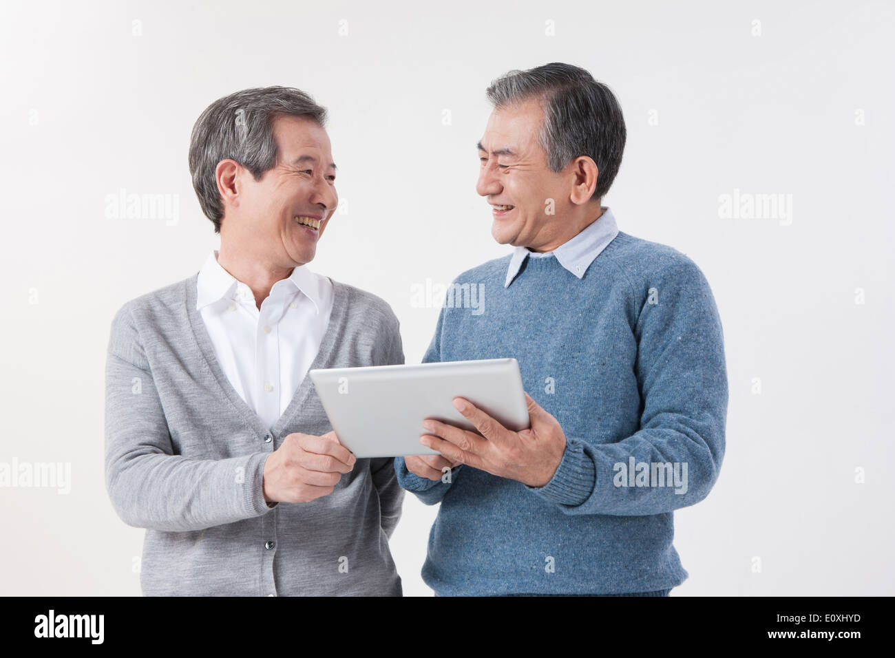 two old men using a tablet Stock Photo - Alamy