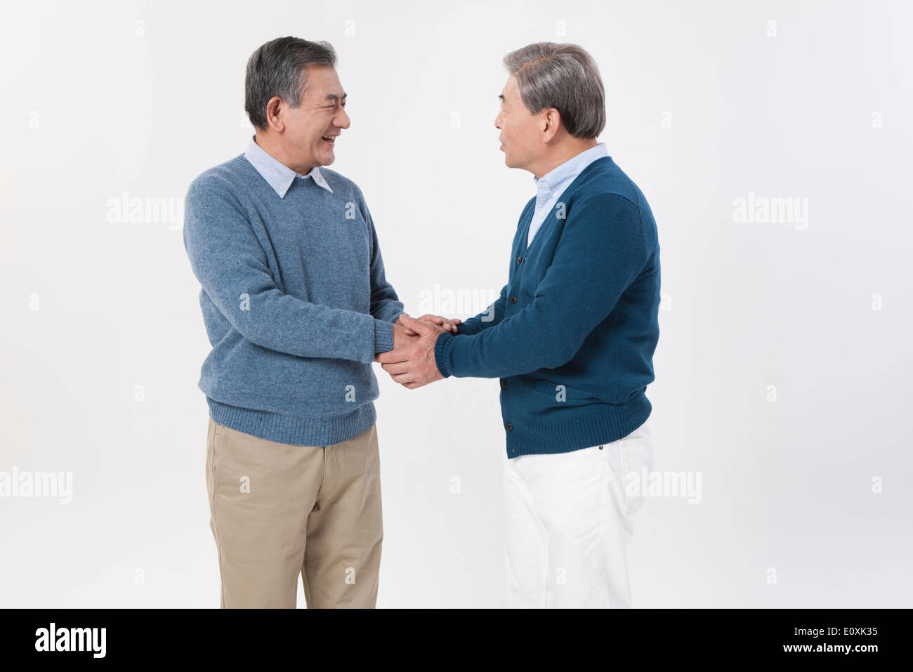 two old men shaking hands Stock Photo - Alamy