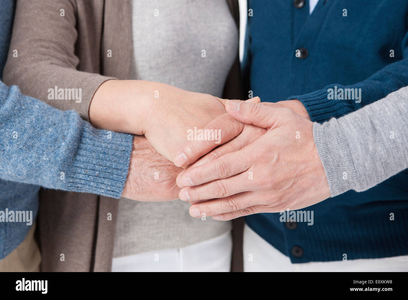 a group of old people holding hands Stock Photo - Alamy