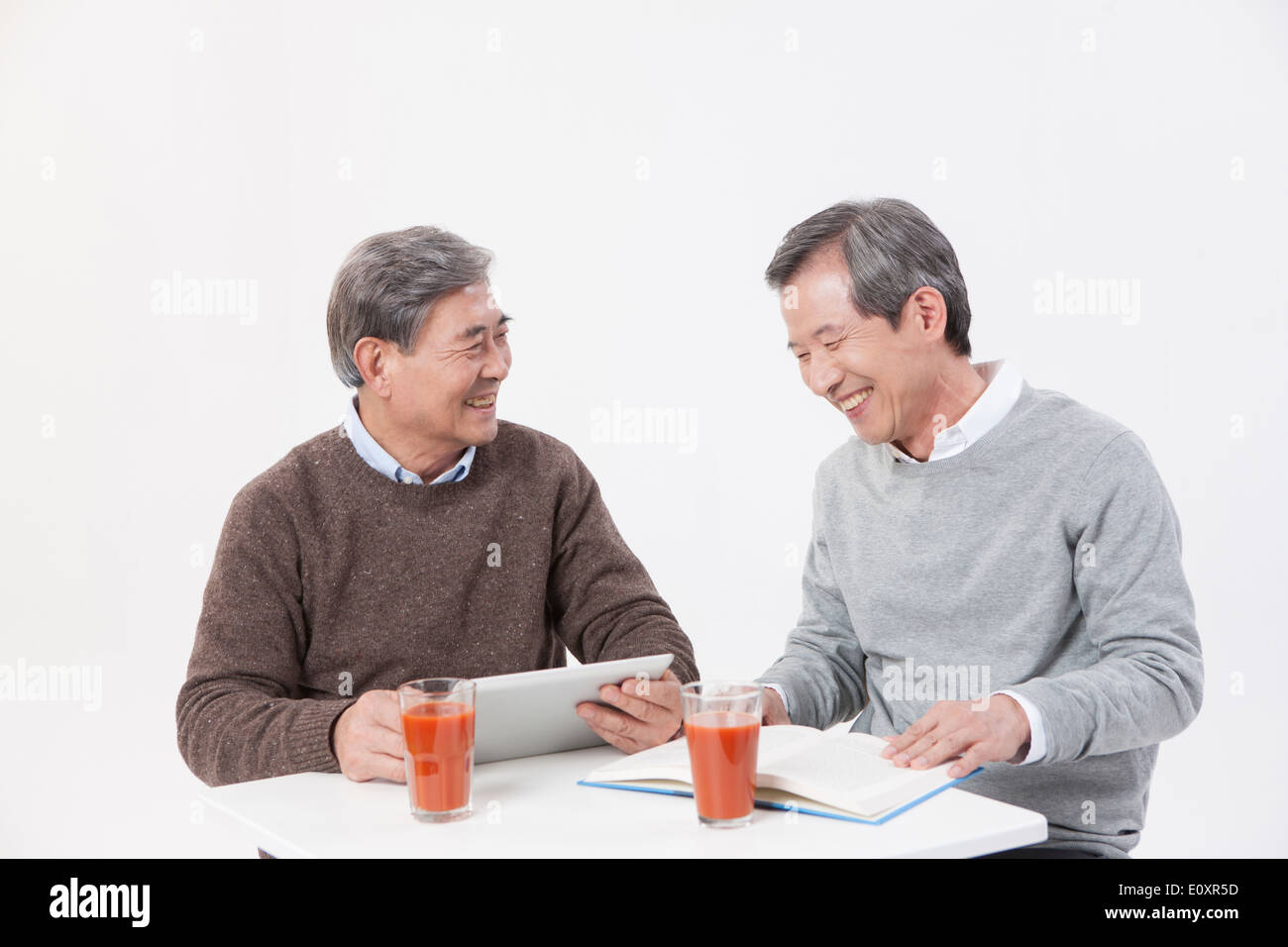 two old men reading at the table Stock Photo - Alamy