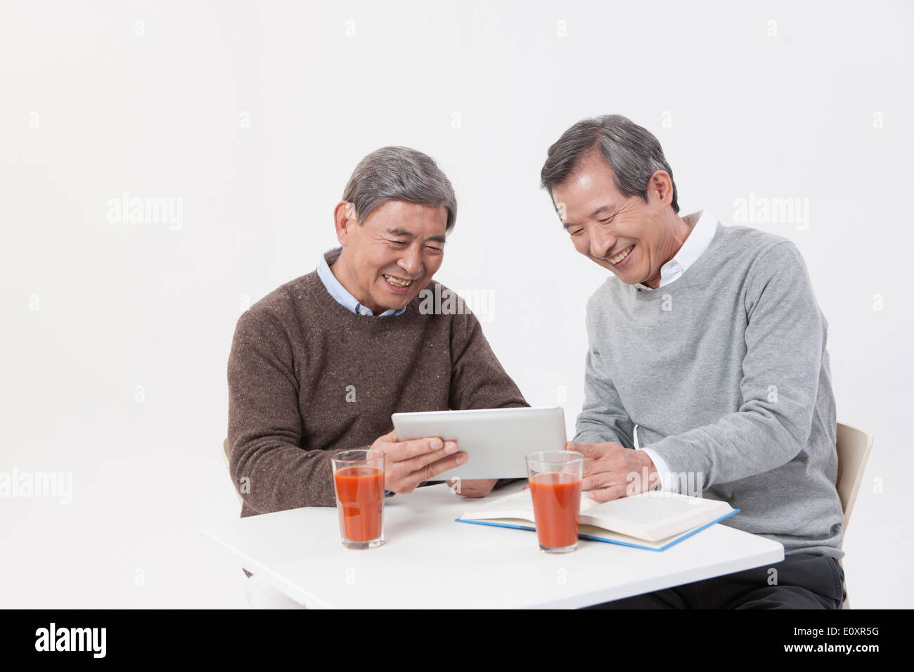 two old men reading at the table Stock Photo - Alamy
