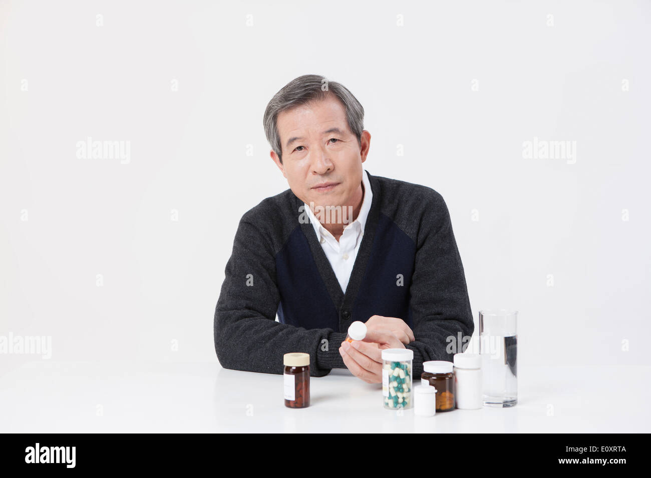 an old man taking medicine Stock Photo - Alamy