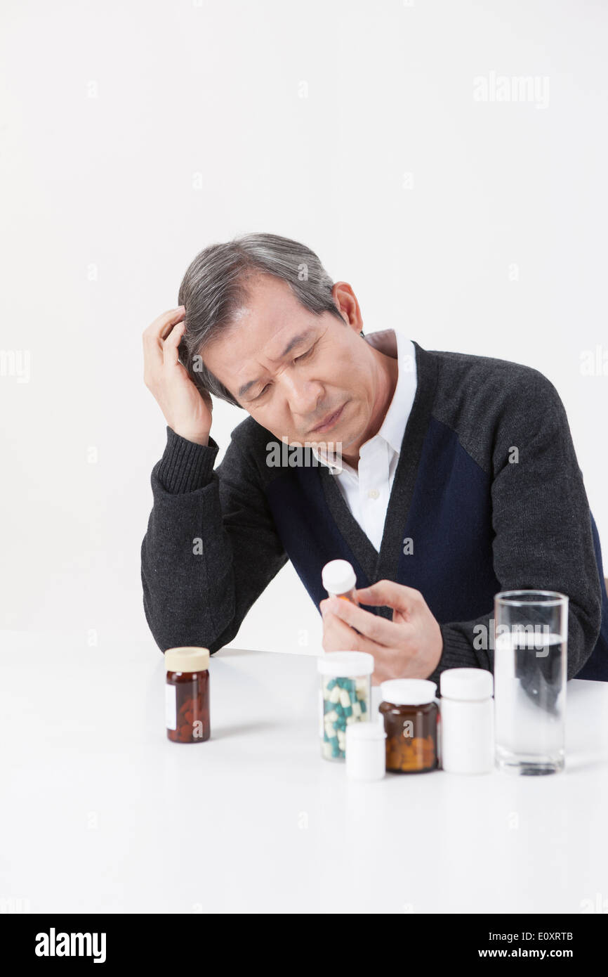 an old man taking medicine Stock Photo - Alamy