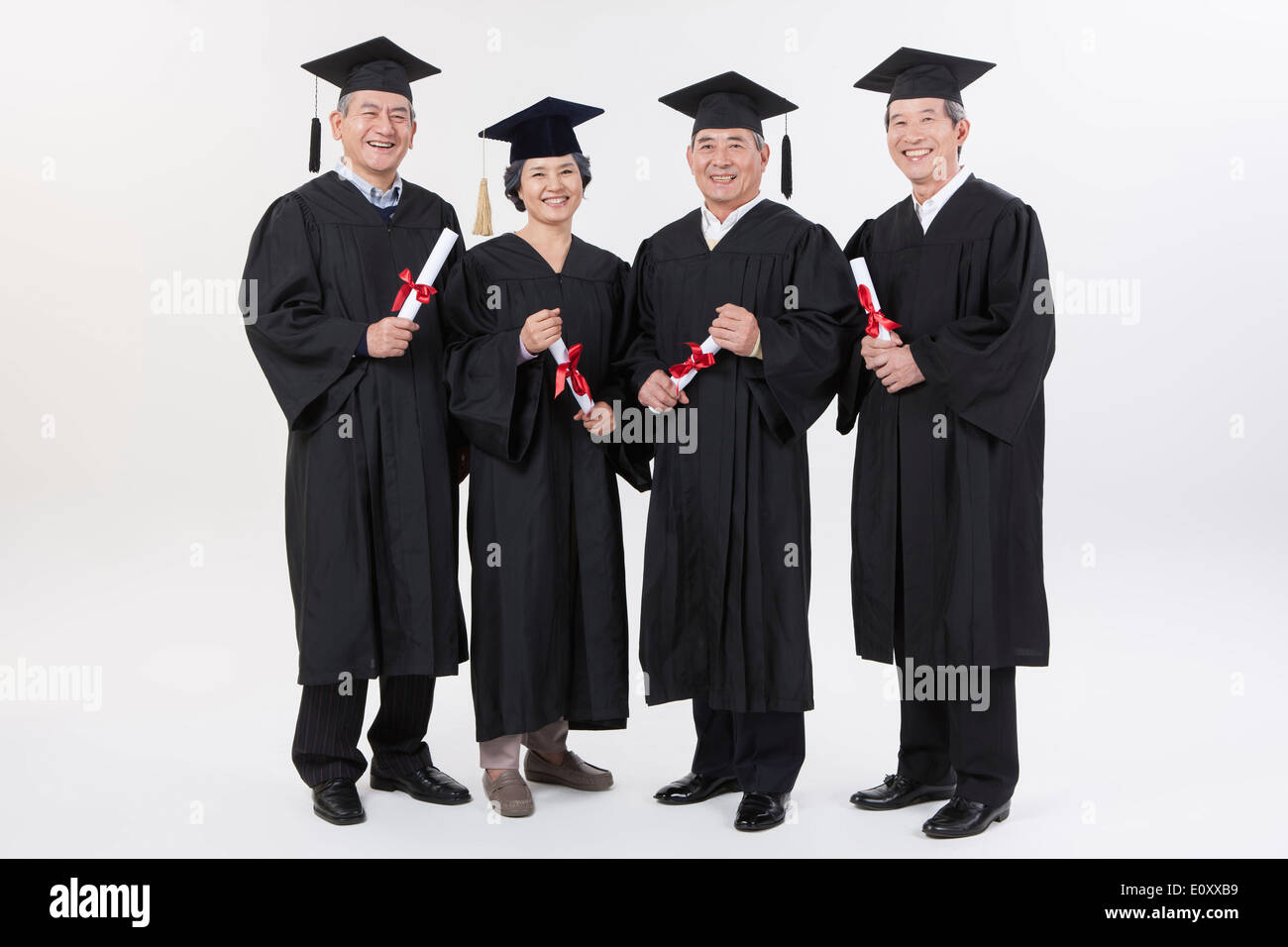 old people posing in graduation outfits Stock Photo - Alamy