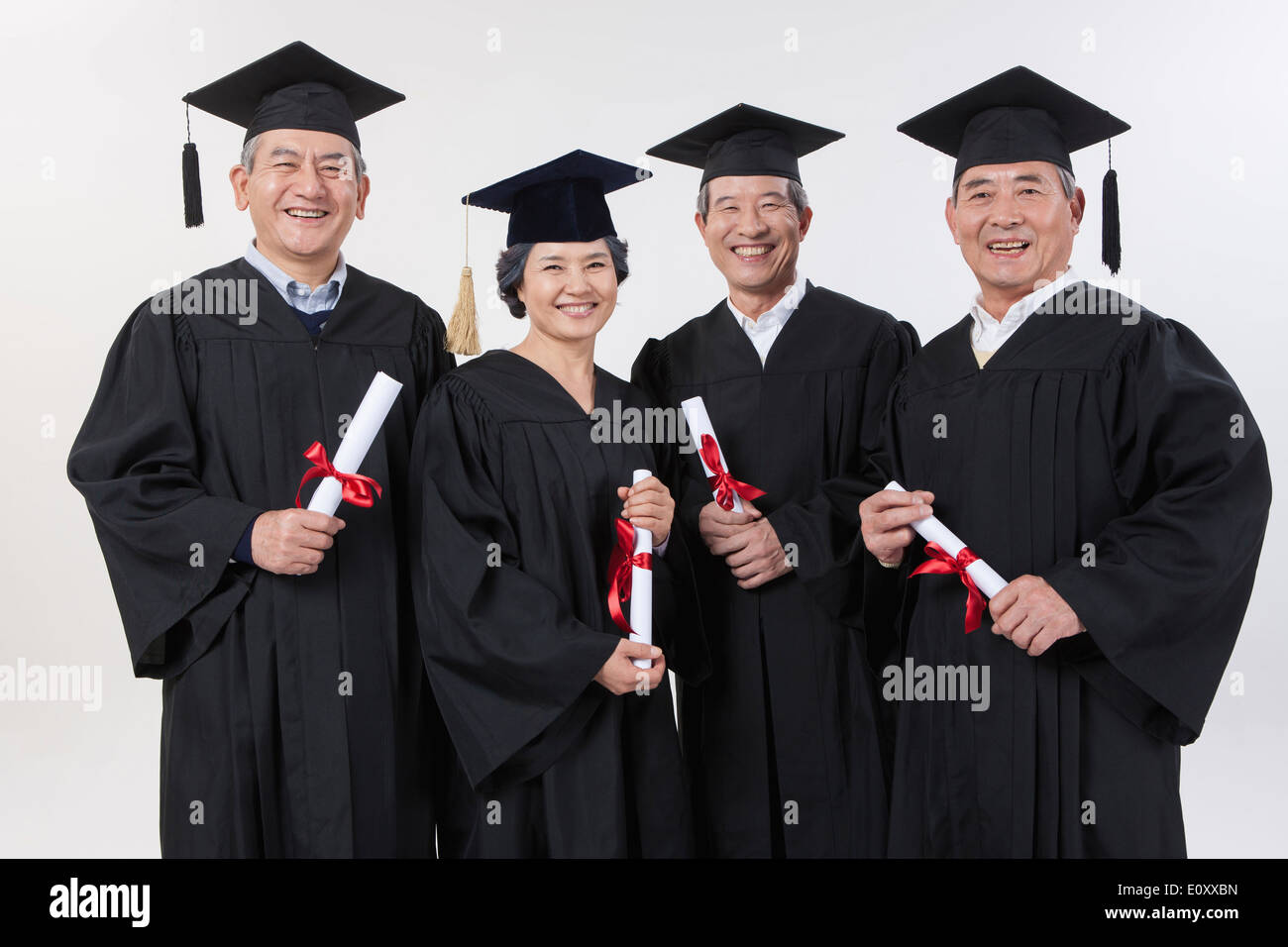 old people posing in graduation outfits Stock Photo - Alamy
