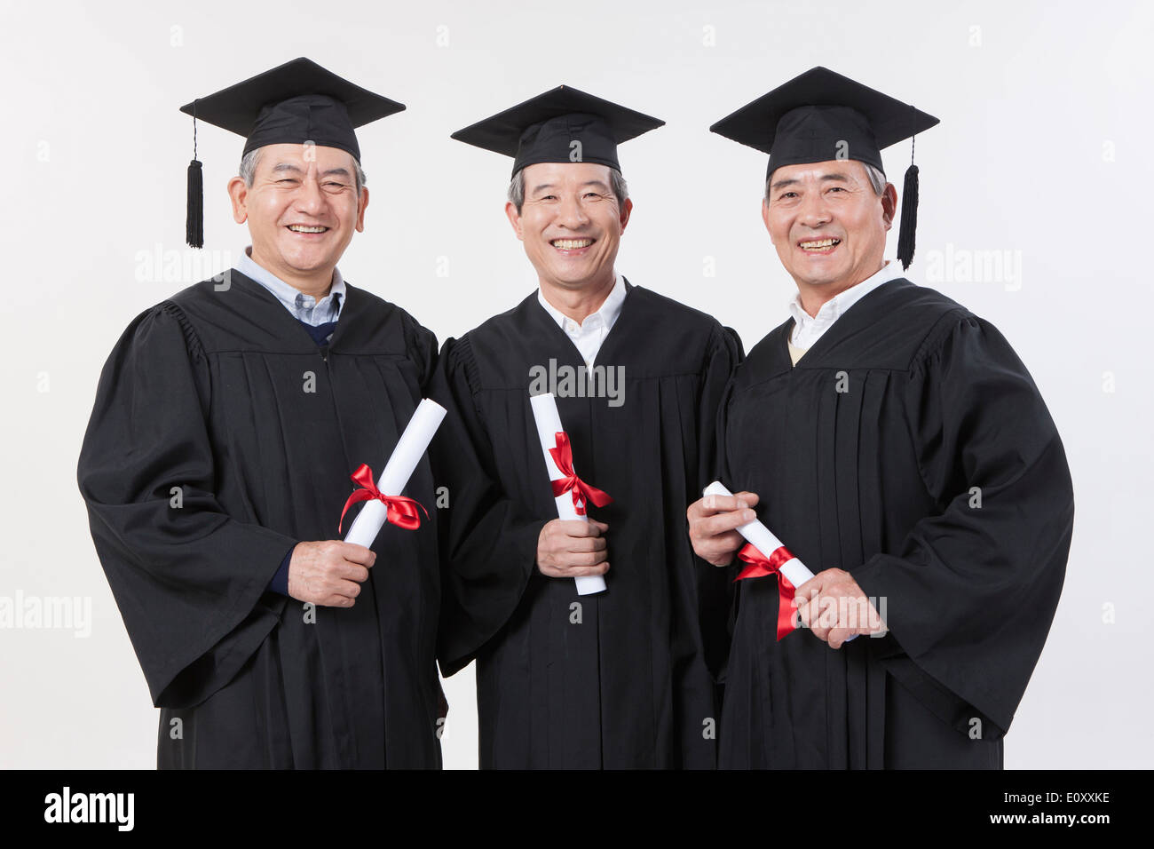 old people posing in graduation outfits Stock Photo - Alamy