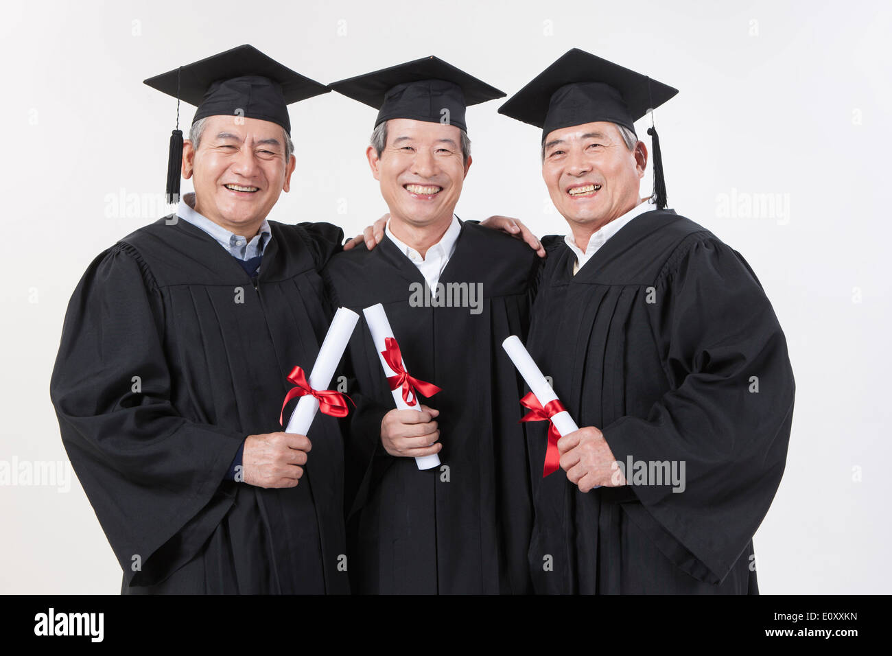 old people posing in graduation outfits Stock Photo - Alamy