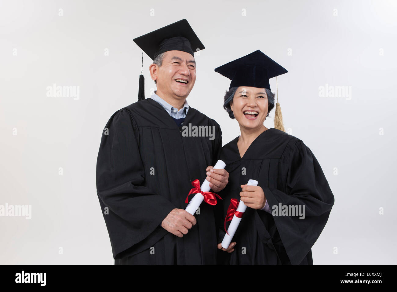 old people posing in graduation outfits Stock Photo - Alamy