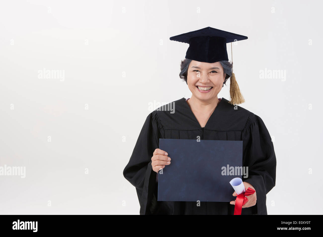 an old woman posing in a graduation outfit Stock Photo - Alamy