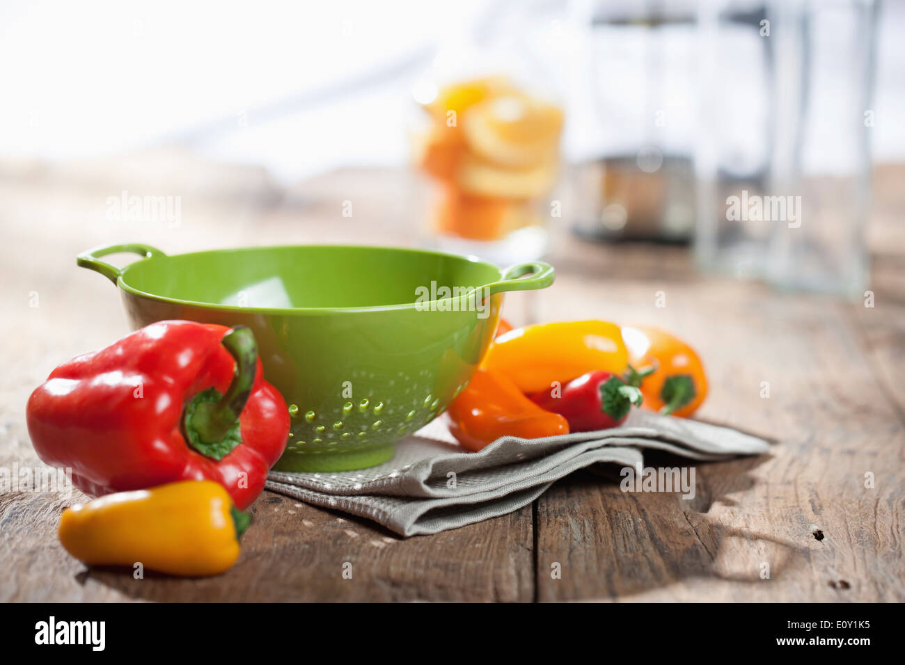 a set of different color bell peppers on a wooden table Stock Photo - Alamy