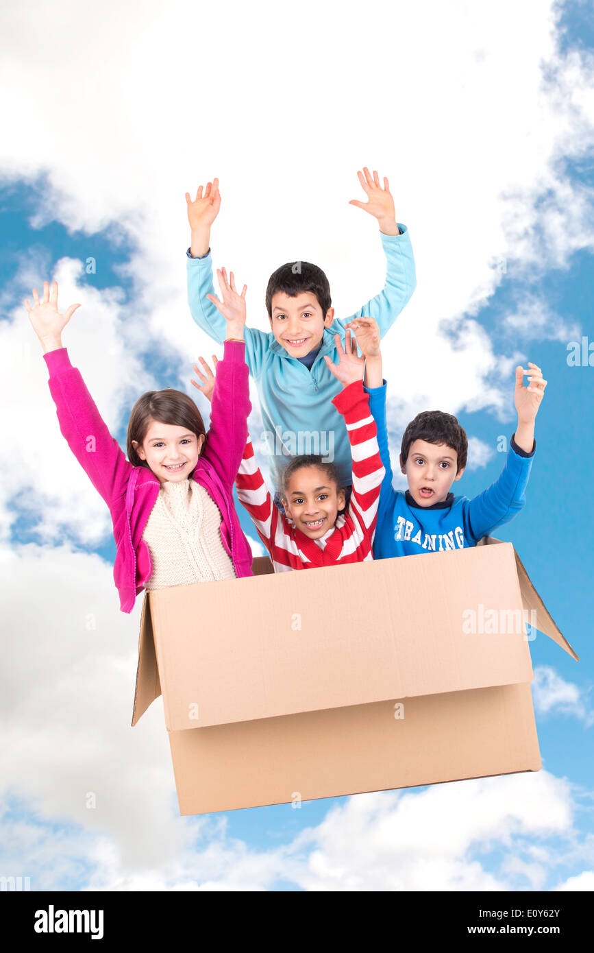 Happy kids inside a cardboard box Stock Photo - Alamy