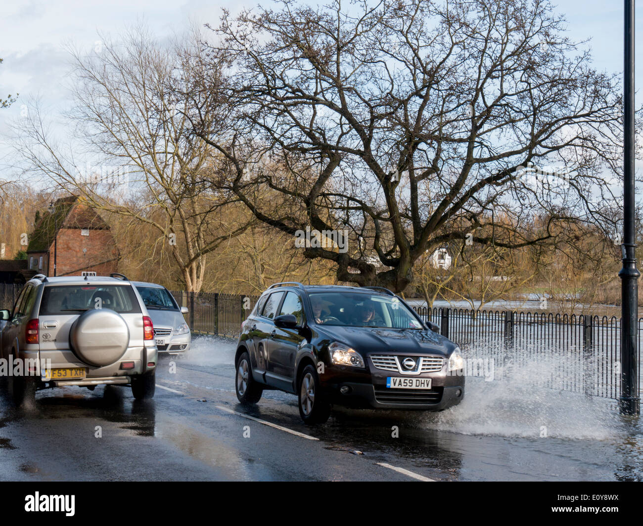 UK, Surrey, Cobham, flood water on road splash Stock Photo - Alamy