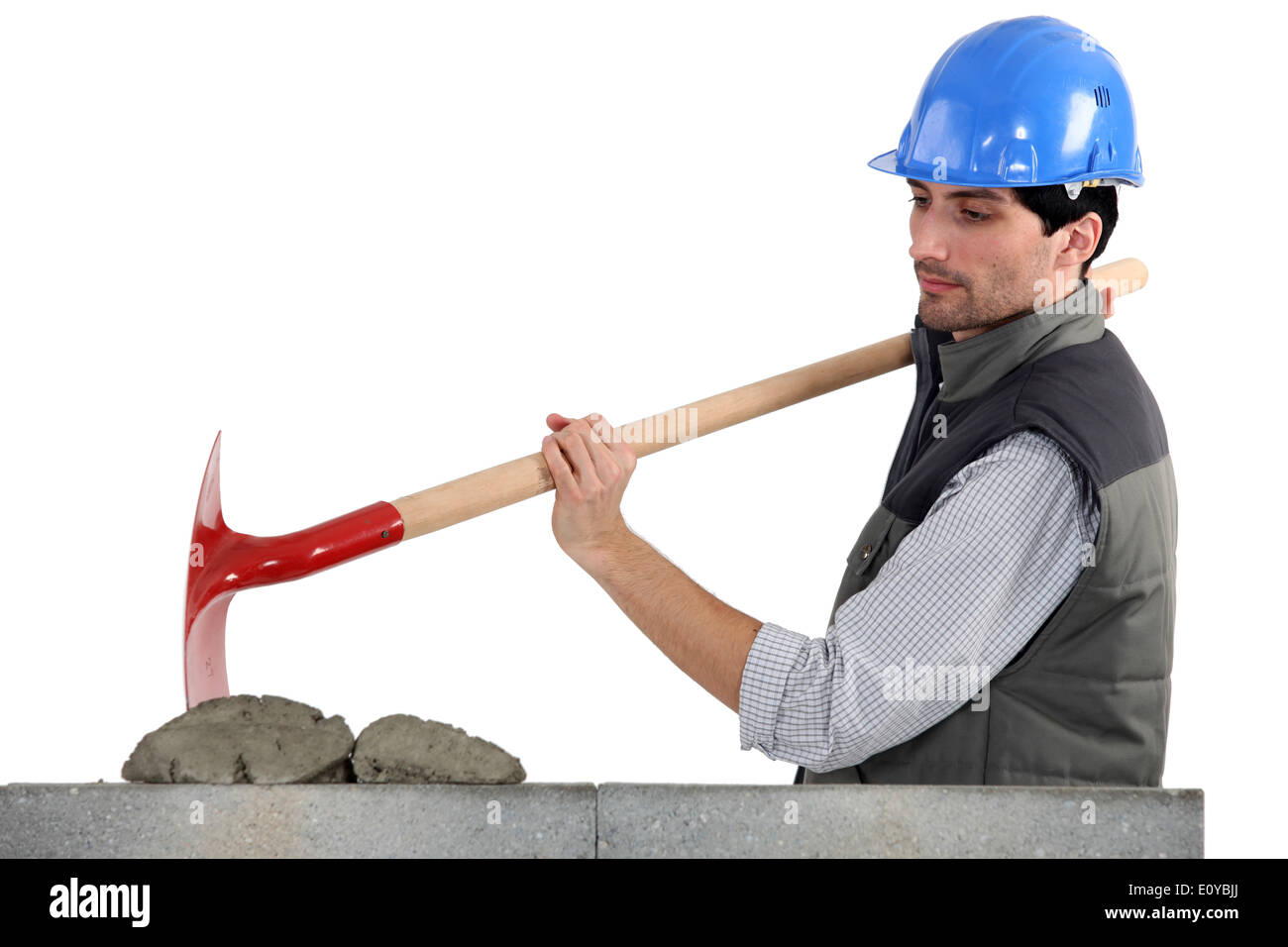 Worker with spade and cement Stock Photo - Alamy