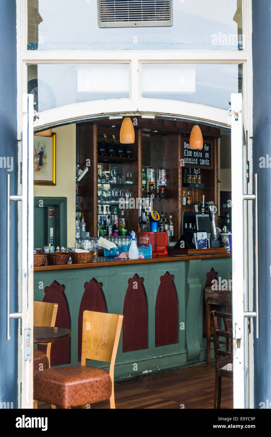 Looking through open double doors into an empty pub at the bar Stock ...