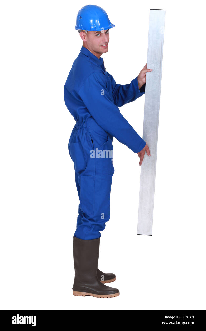 Man stood holding metal beam Stock Photo - Alamy