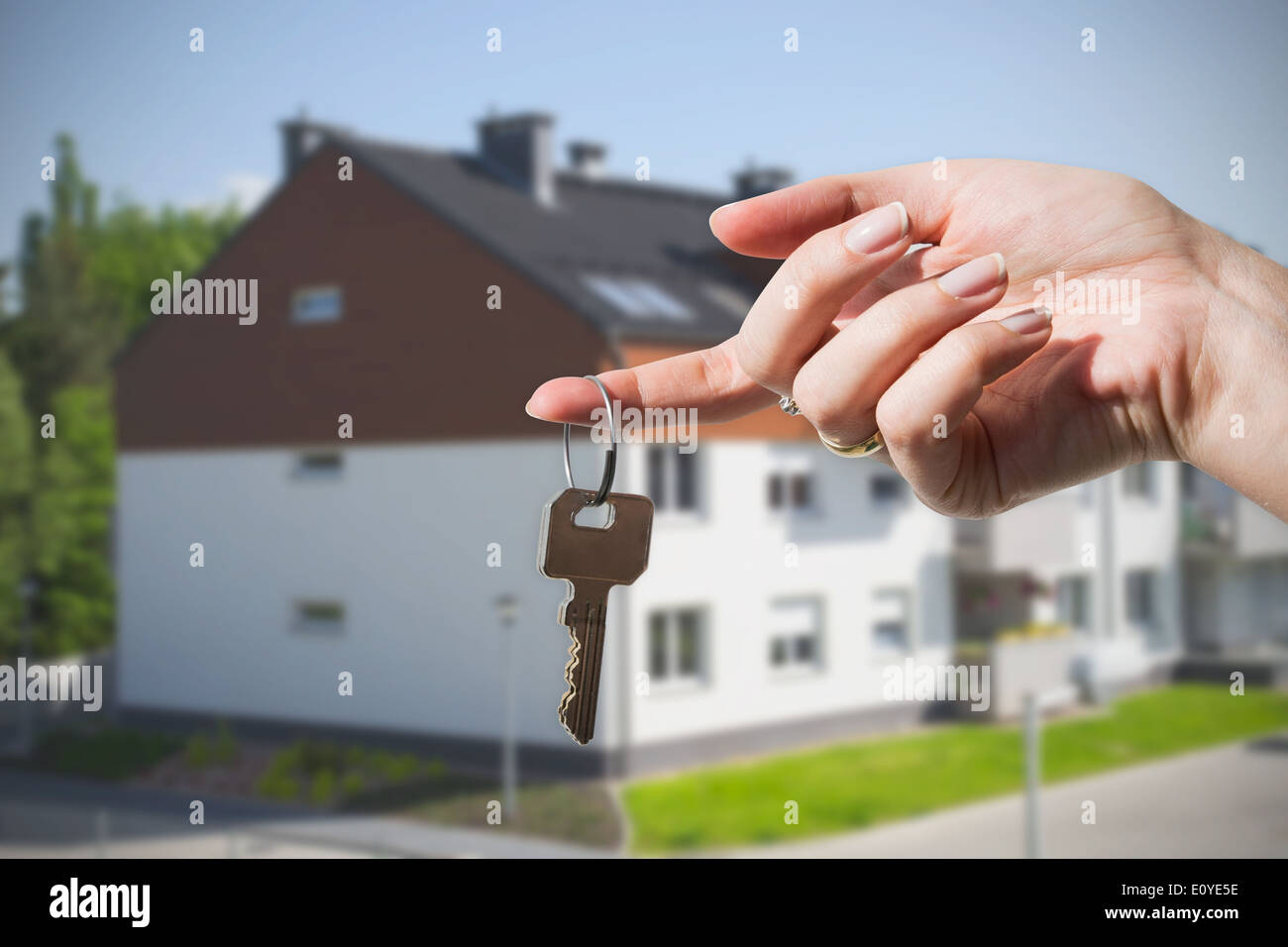 Woman's hand holding keys to new house Stock Photo - Alamy