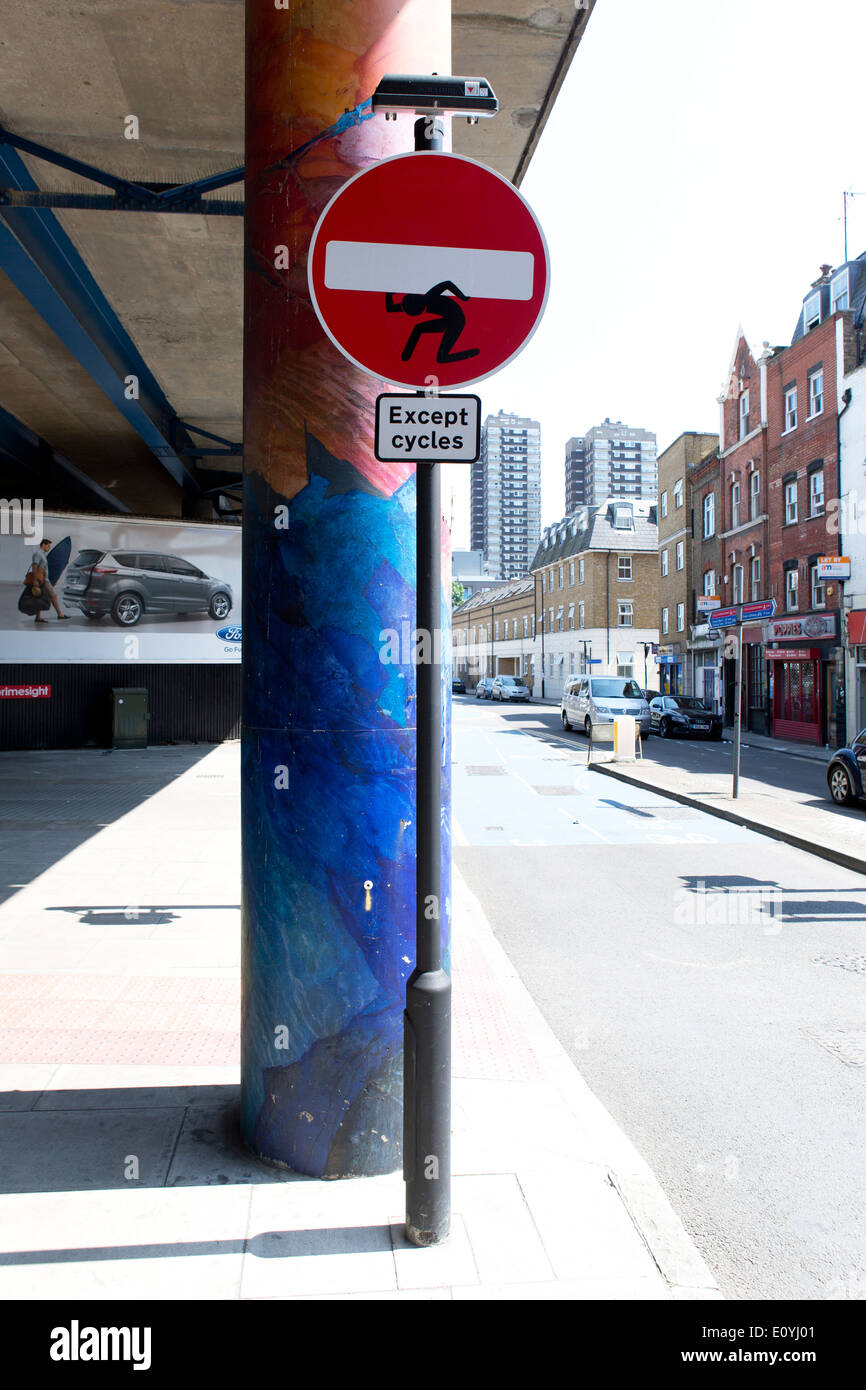 Graffiti on a No Entry street sign, Cable Street, London, England, UK ...