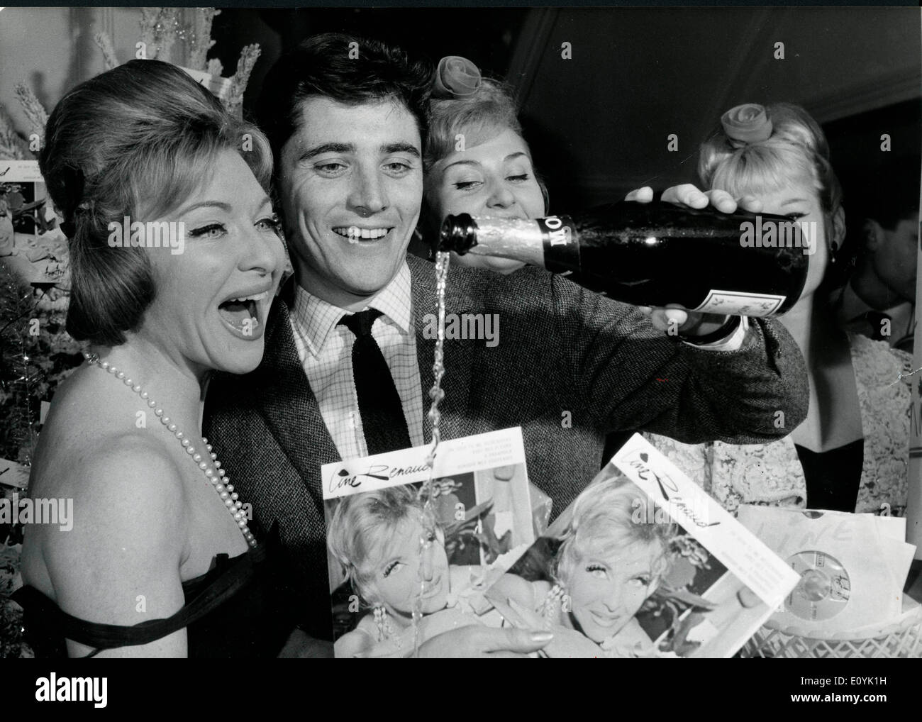 Singer Sacha Distel pours champagne Stock Photo - Alamy