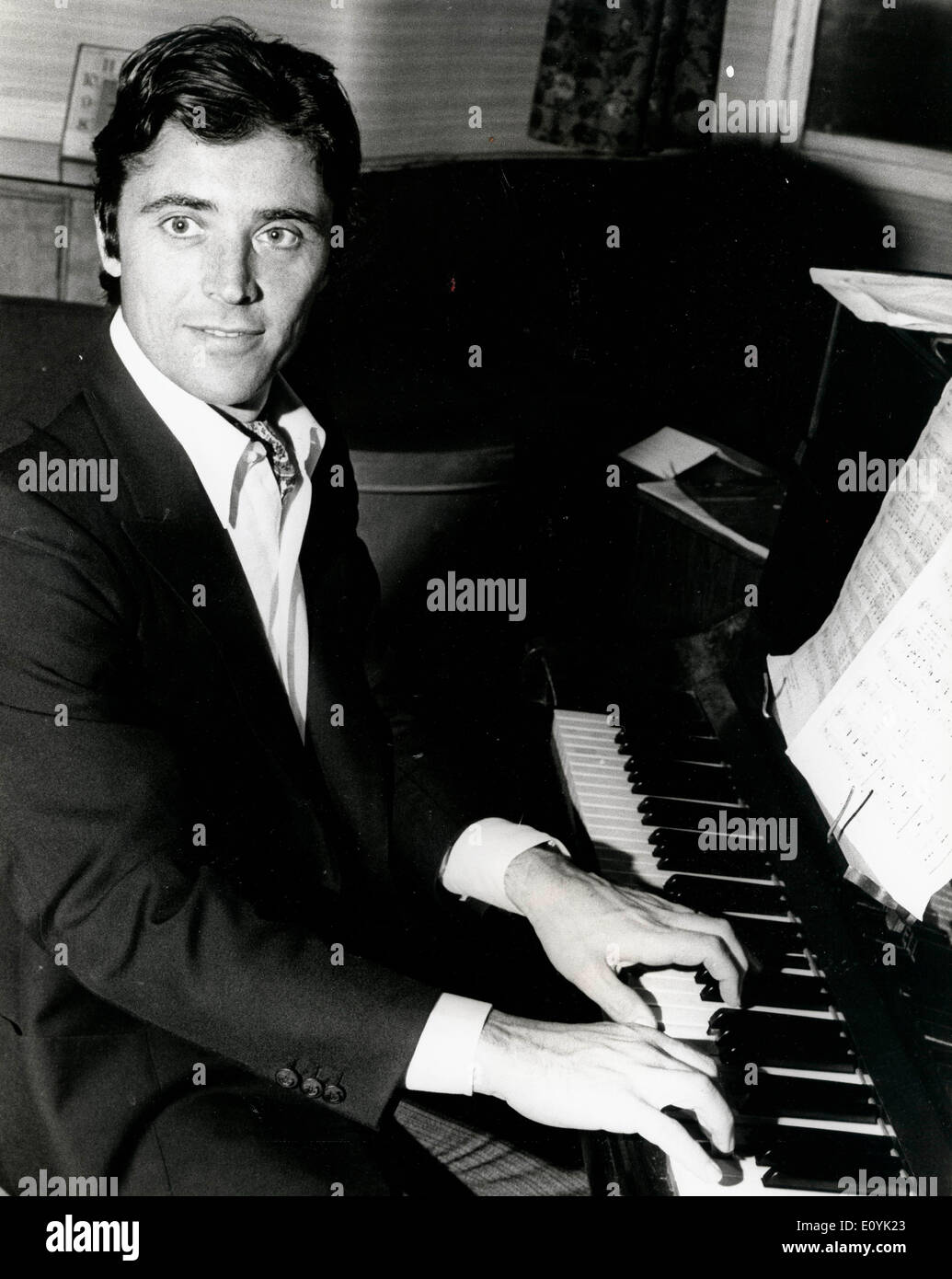 Singer Sacha Distel plays the piano Stock Photo - Alamy