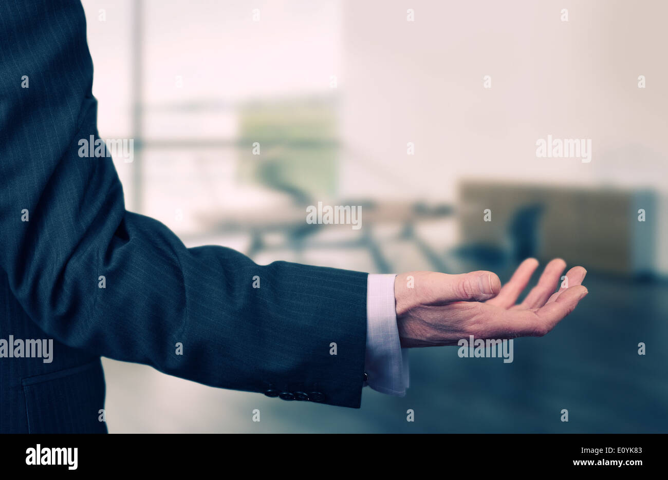 A businessman reaching out to offer assistance Stock Photo - Alamy