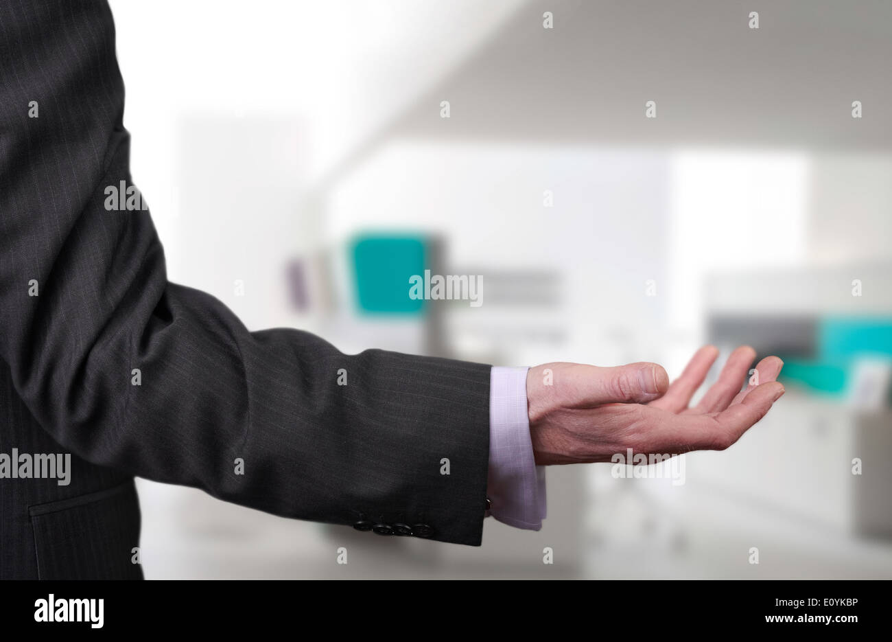 A businessman reaching out to offer assistance Stock Photo - Alamy