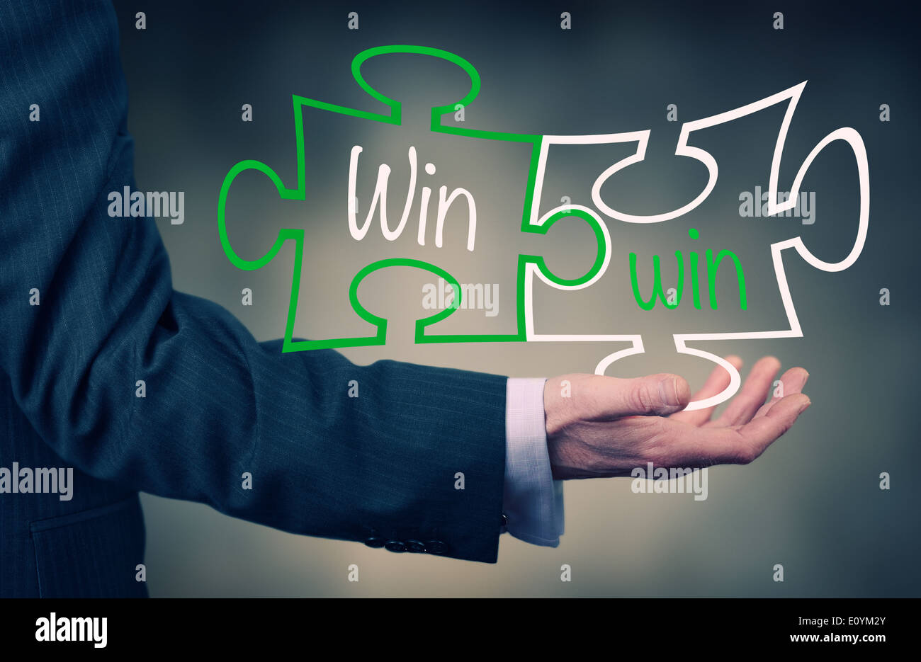 A Businessman holding at a Win Win Success puzzle concept Stock Photo ...