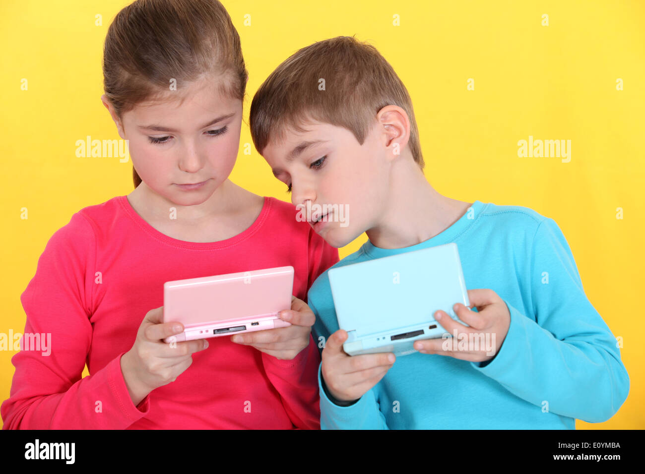 Children playing with handheld game console Stock Photo - Alamy