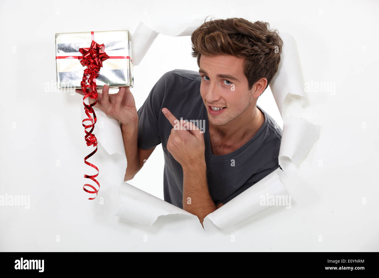 Man with a wrapped gift Stock Photo - Alamy