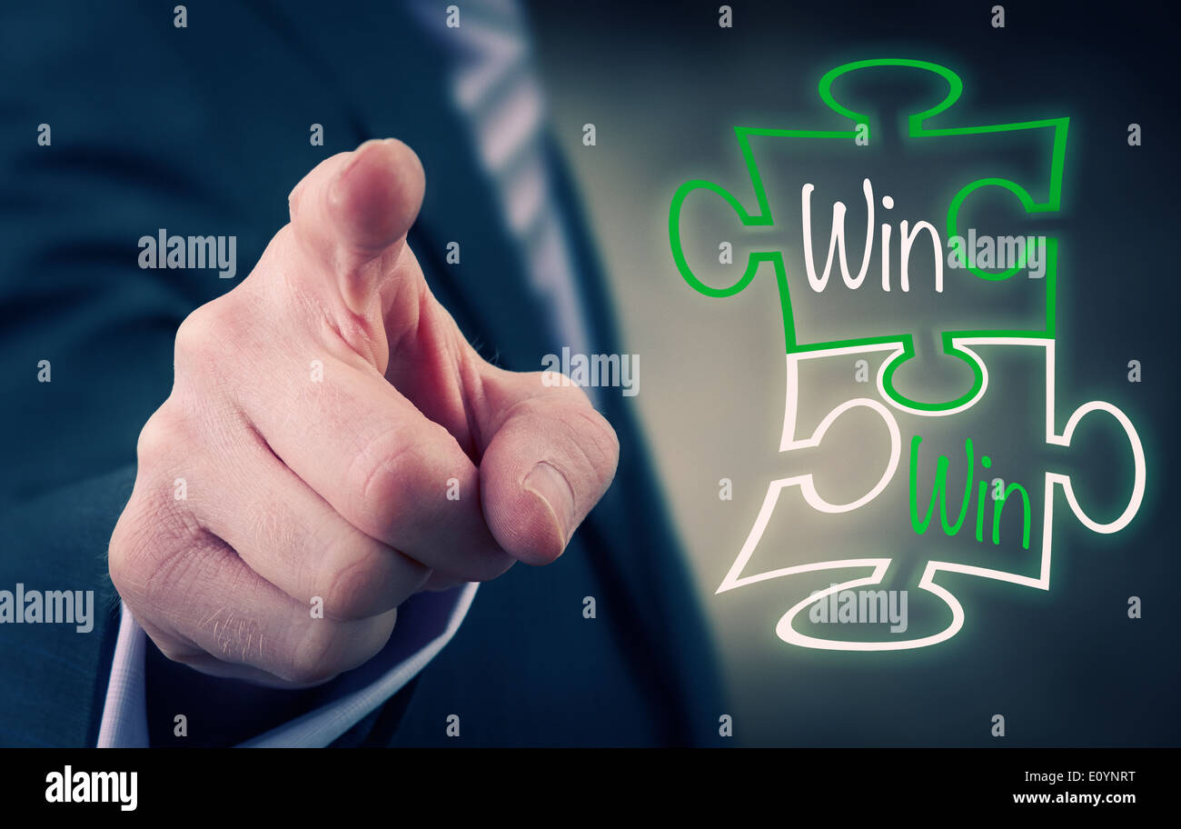 A Businessman Pointing at a Win Win Success puzzle concept Stock Photo ...
