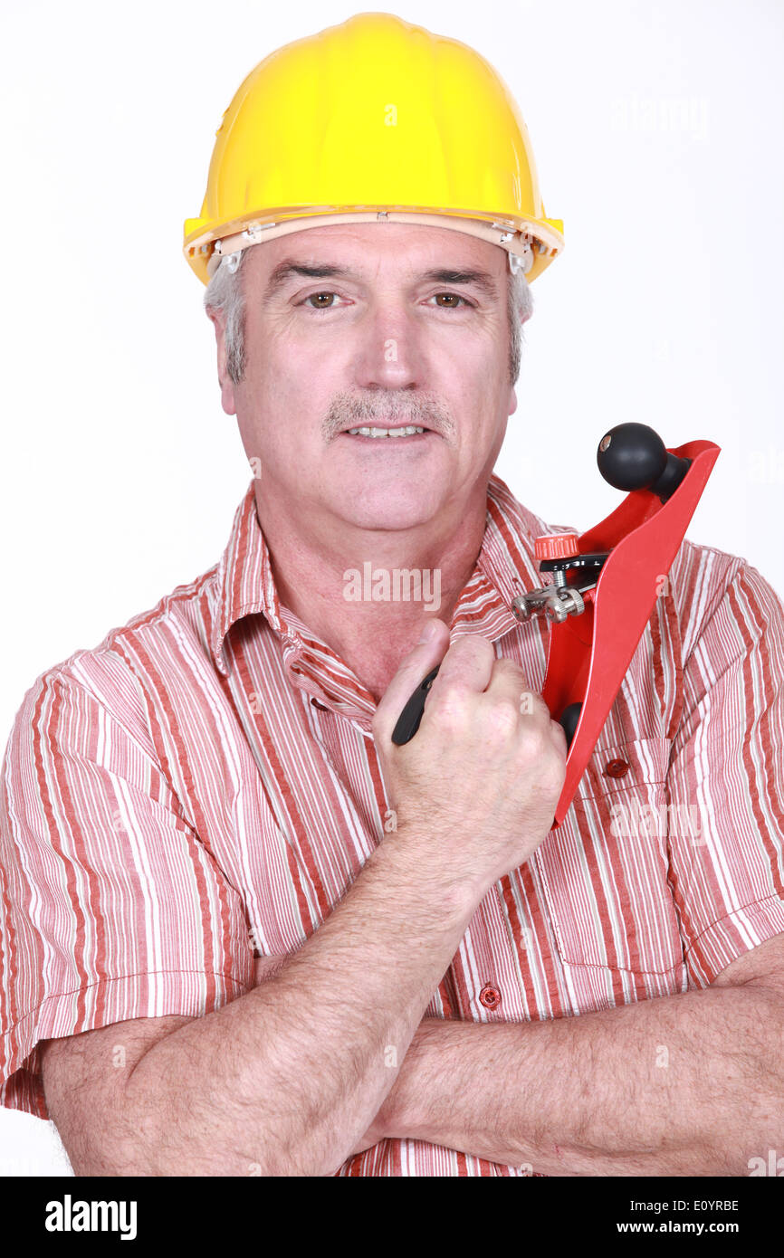 Man with hand tool Stock Photo - Alamy