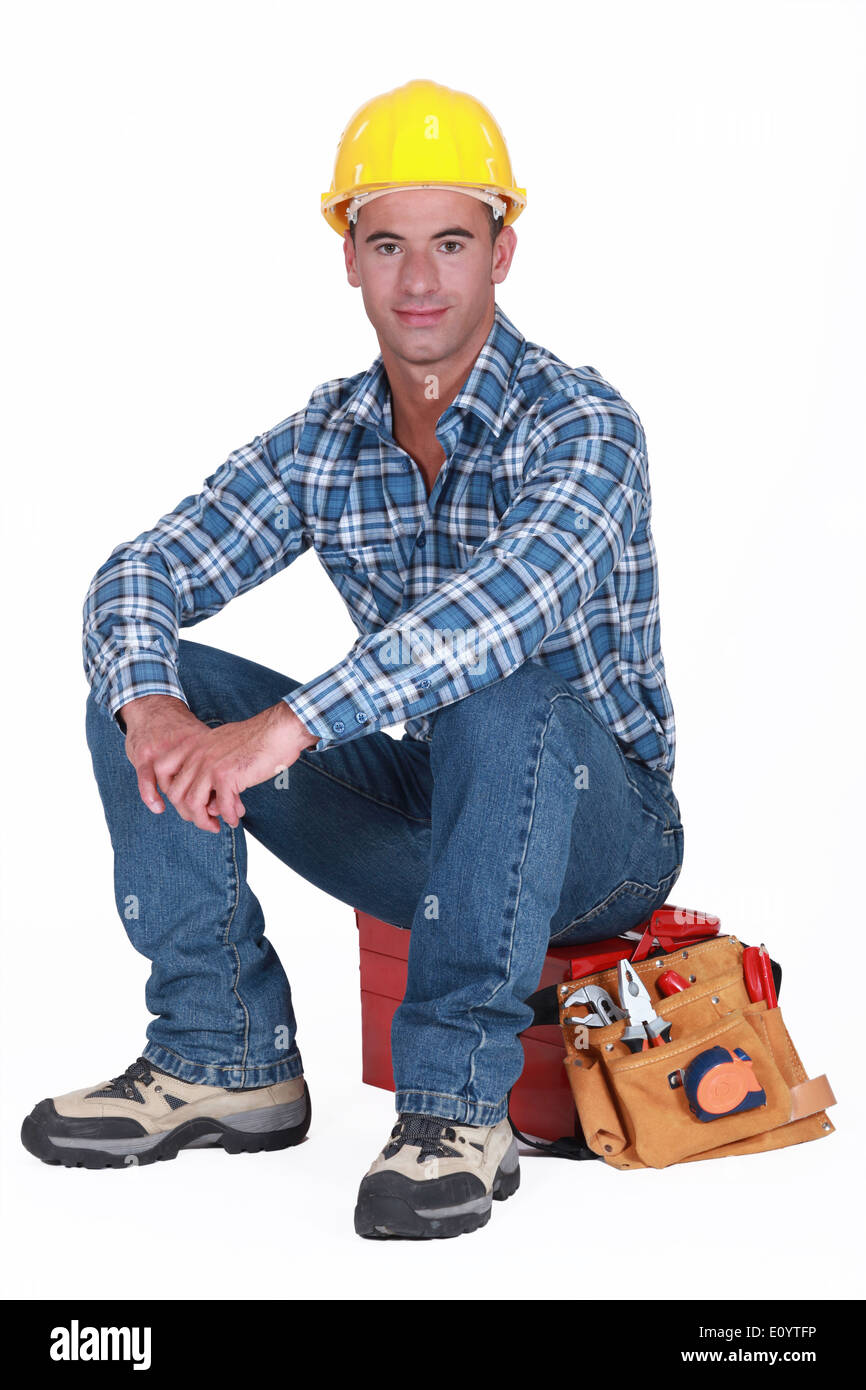 A construction worker sitting on his toolbox Stock Photo - Alamy