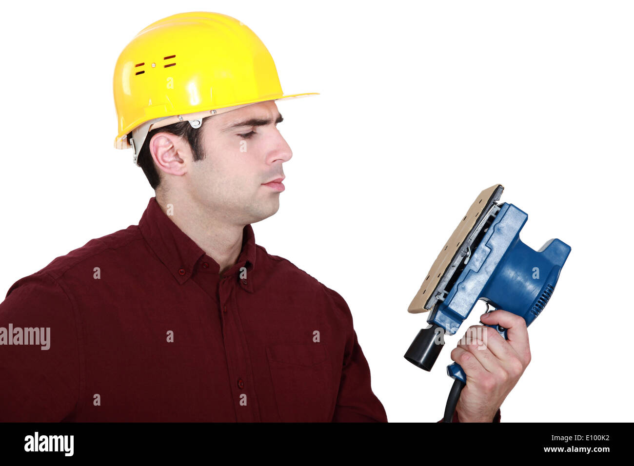 Woodworker looking at a sander Stock Photo - Alamy