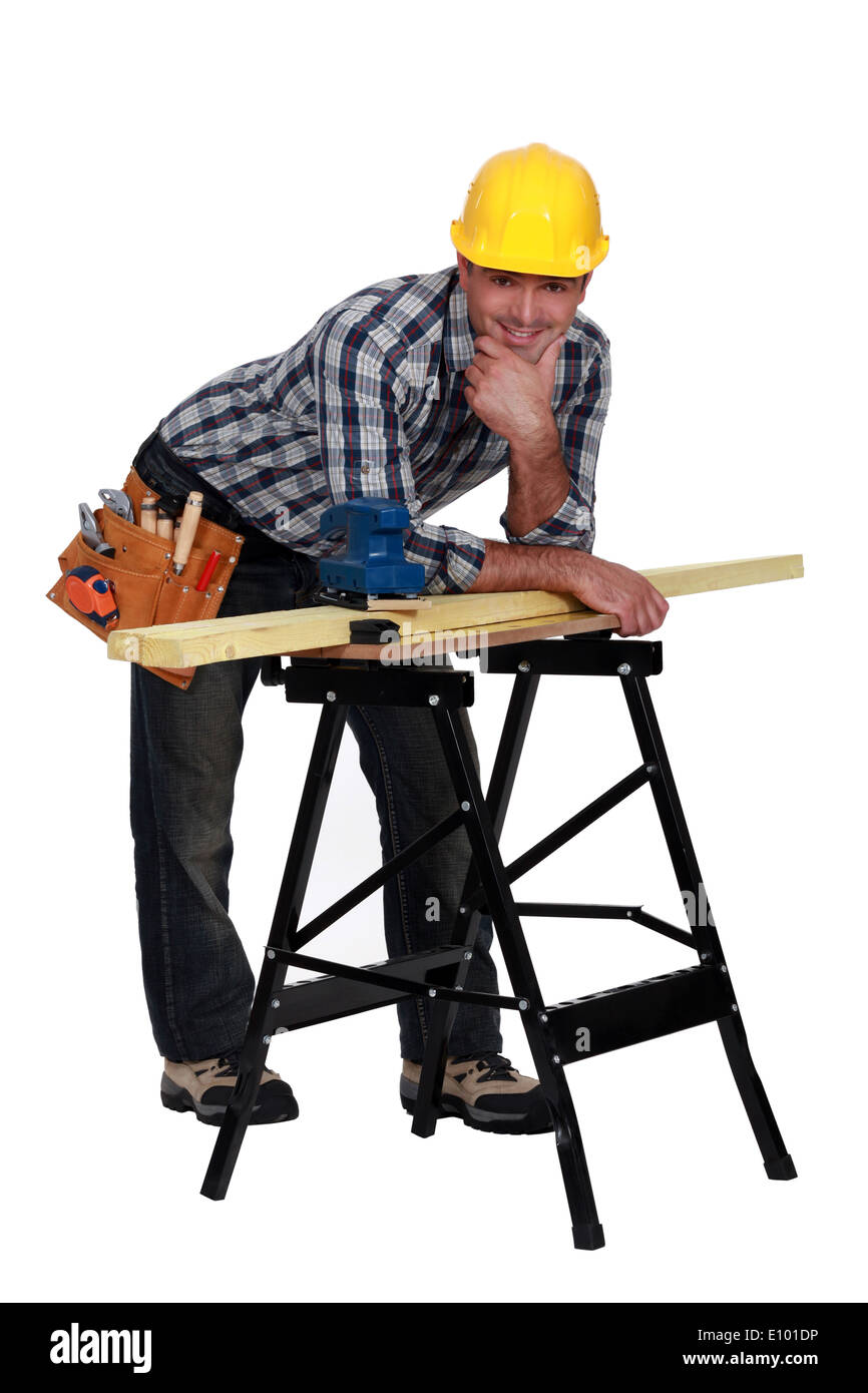 Carpenter leaning on work-bench Stock Photo - Alamy