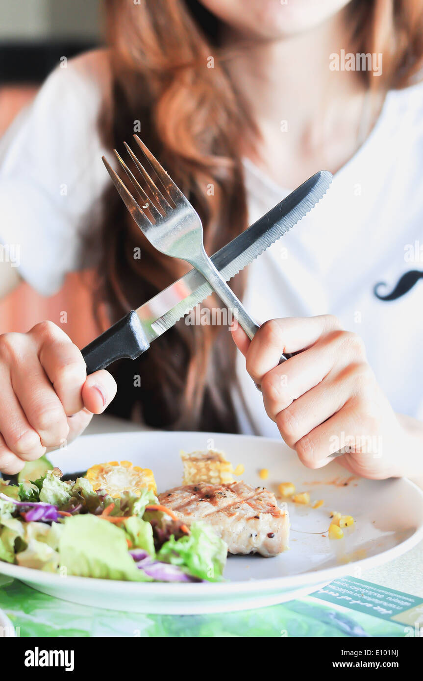 woman holding a fork and a table knife Stock Photo - Alamy