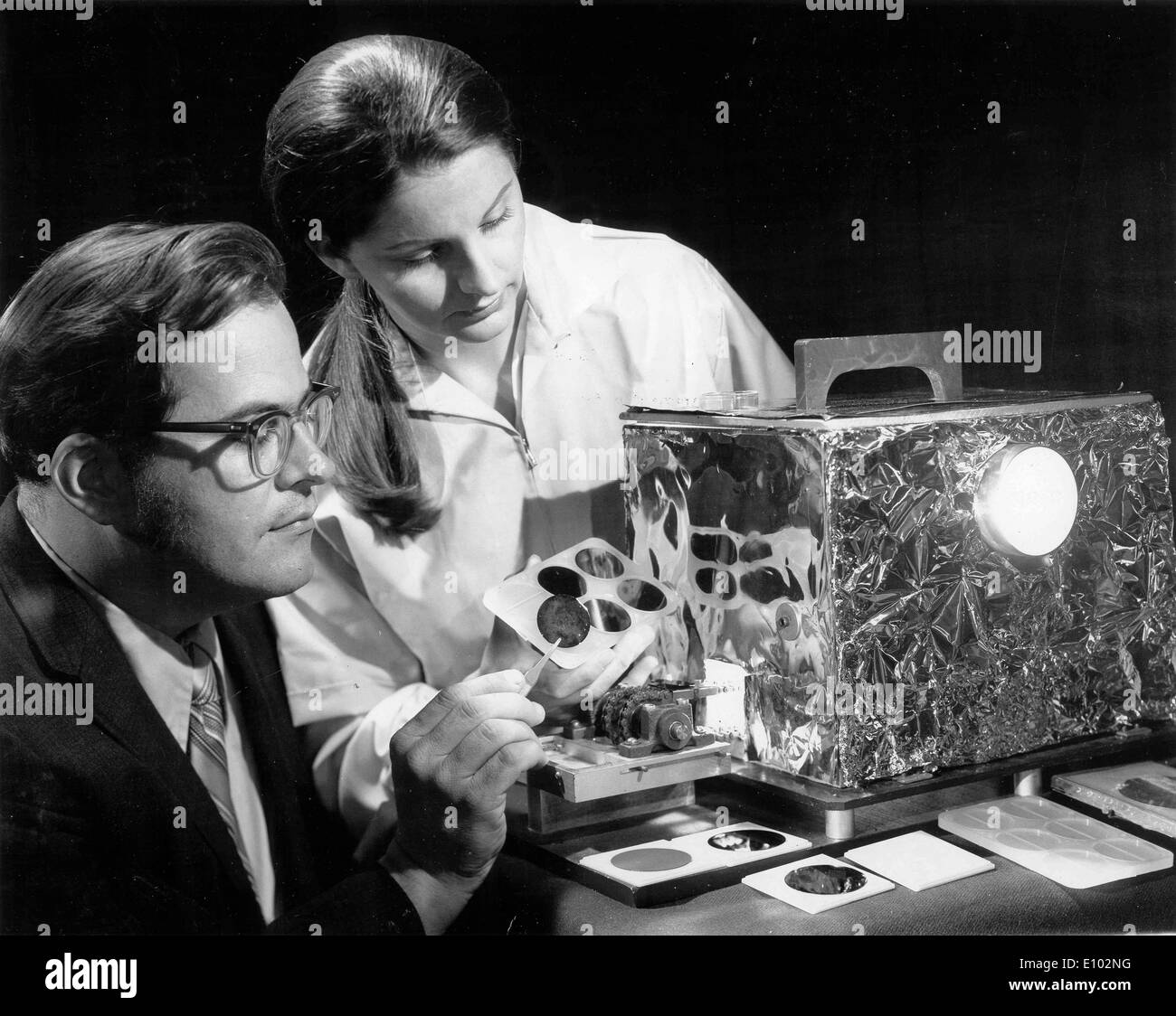 A man and woman test a slide projector Stock Photo - Alamy