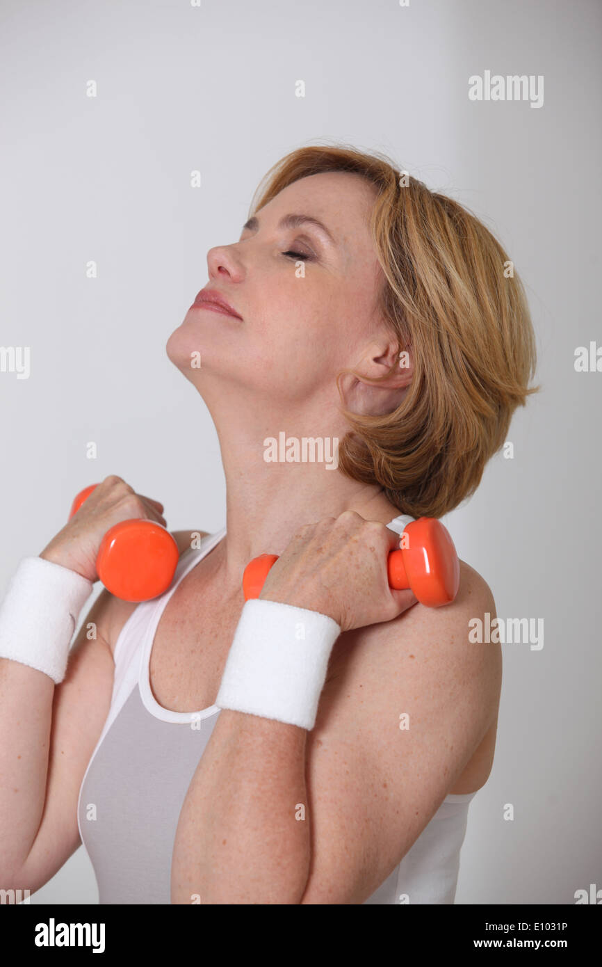 Woman lifting hand weights Stock Photo - Alamy