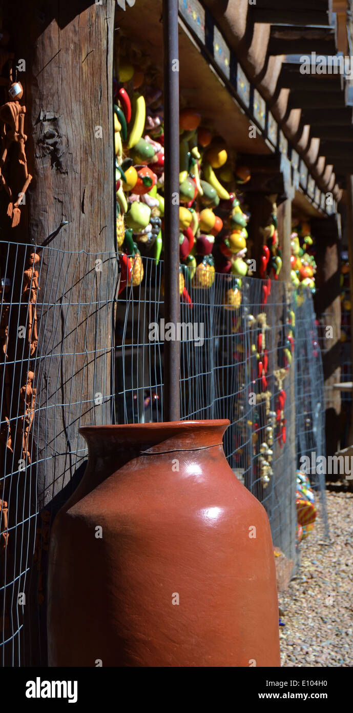 Southwest Clay Pottery With Colorful Hanging Vegetables In Background ...