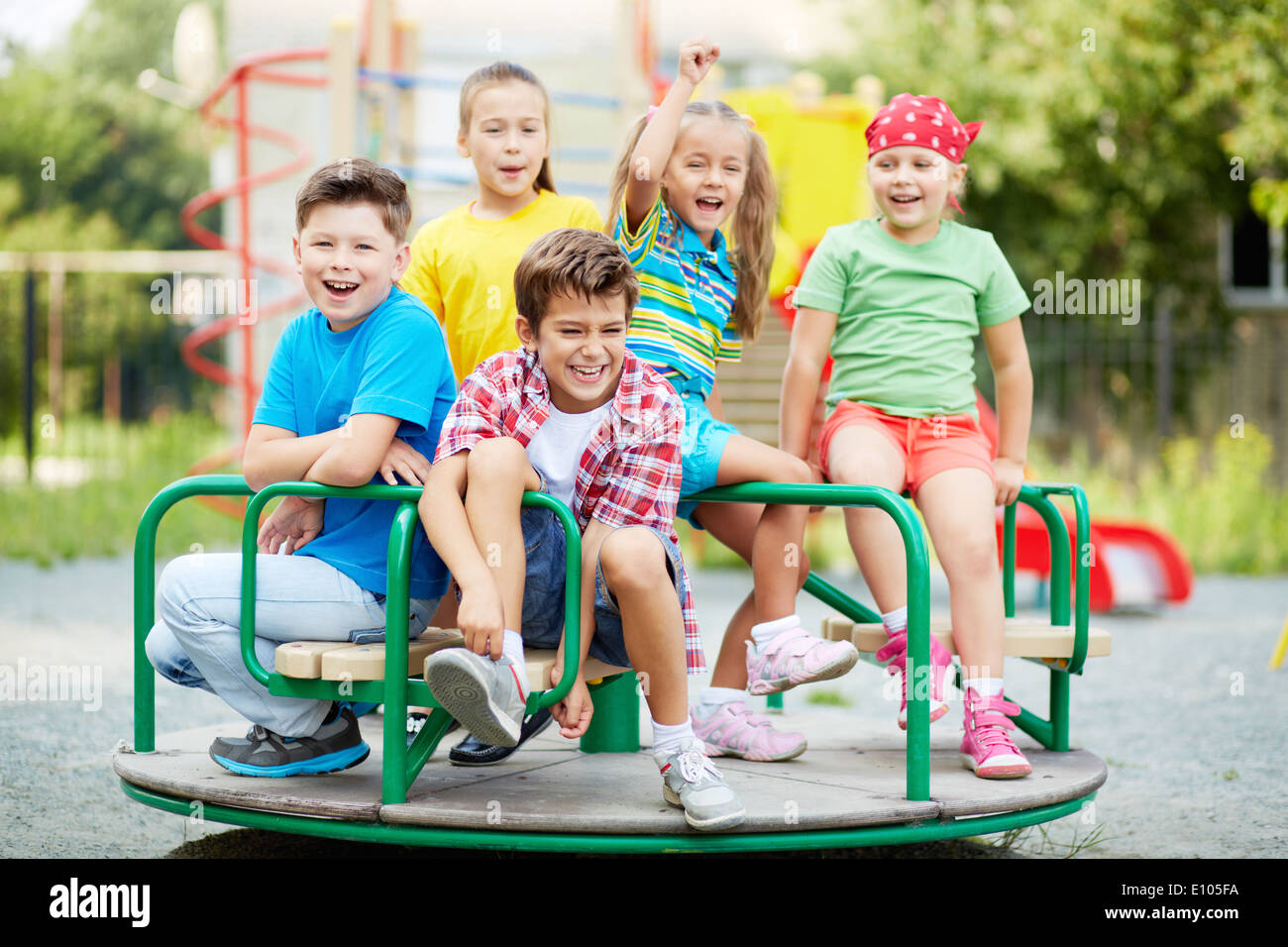 Image of joyful friends having fun on carousel outdoors Stock Photo - Alamy