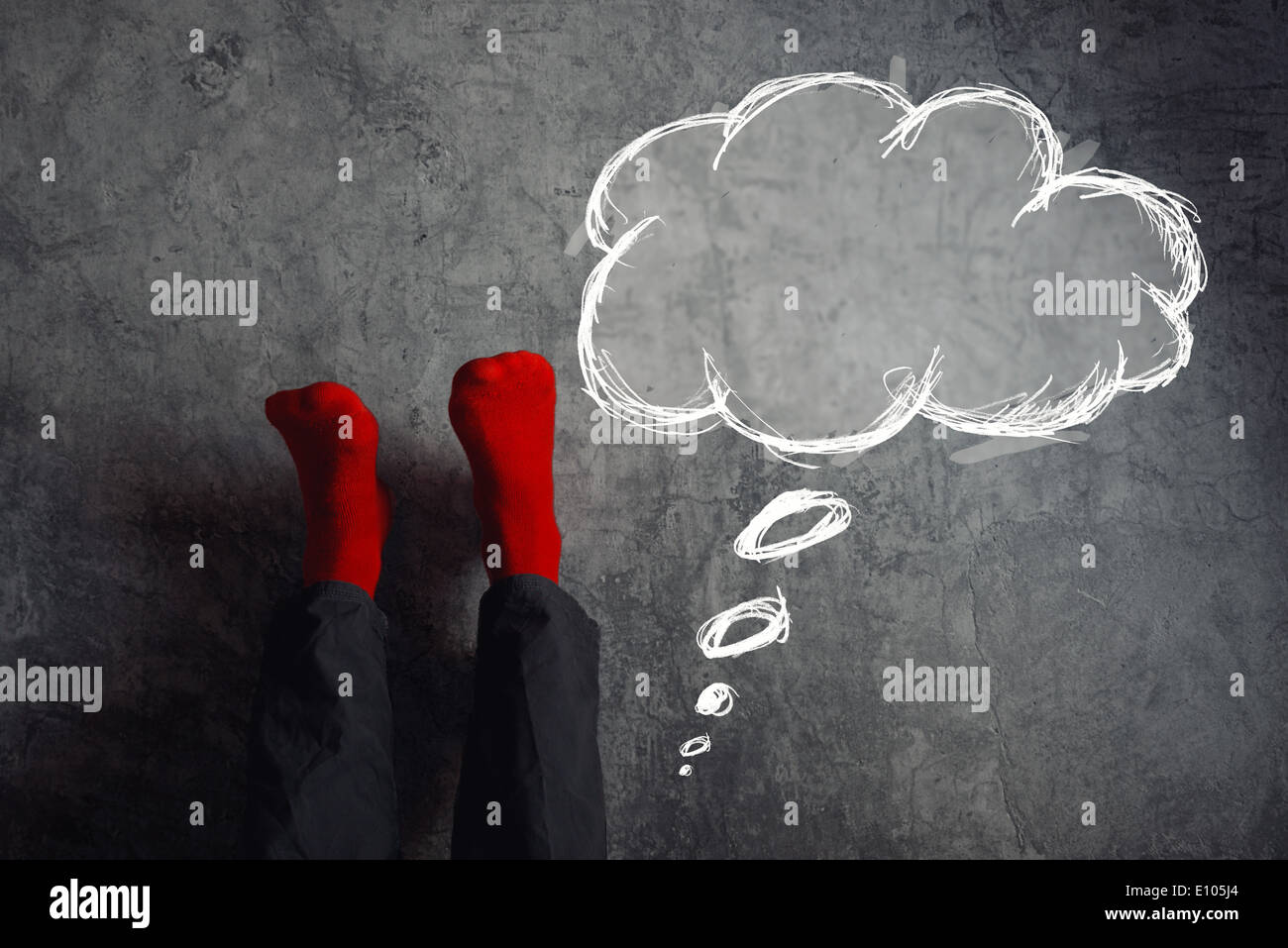 Legs up the wall, putting feet up with think balloon. Man wearing red ...