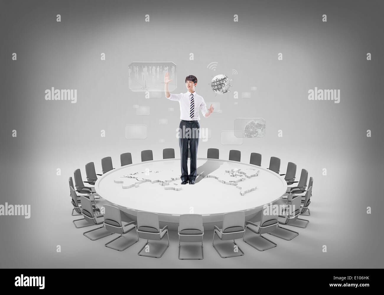 a business man standing on a table with the world map Stock Photo - Alamy