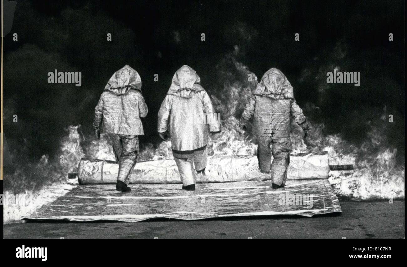 Feb. 09, 1970 - These firemen are rolling this carpet over flames to ...