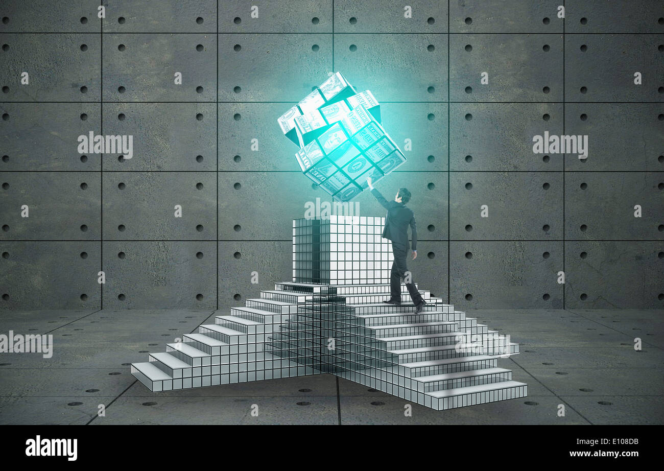 a business man walking up the stairs to a cube Stock Photo - Alamy