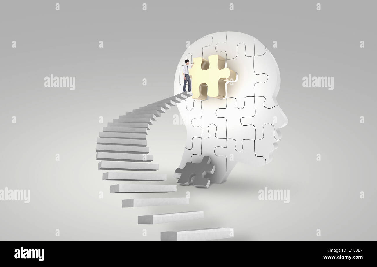 a business man walking the stairs up to a head Stock Photo - Alamy