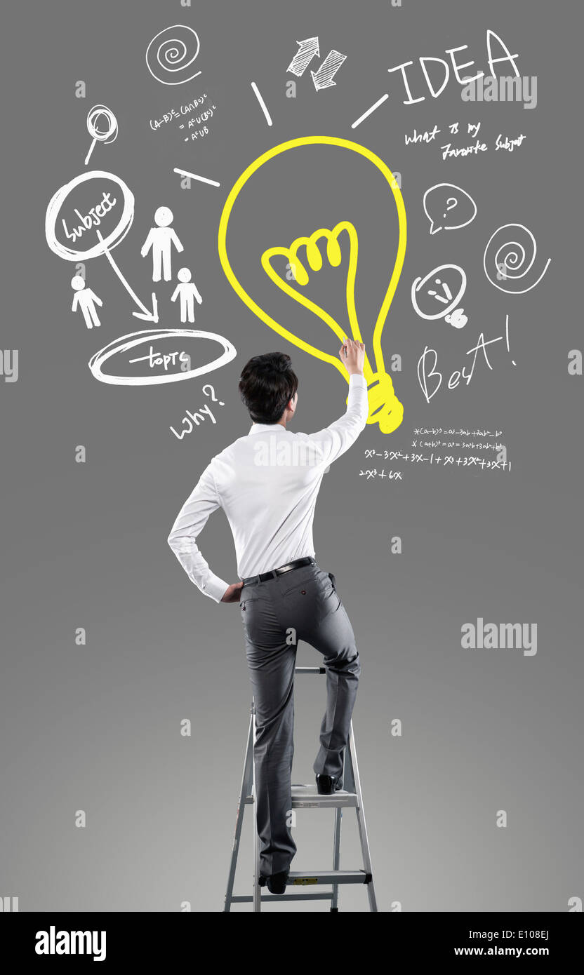 a business man reaching towards a light bulb Stock Photo - Alamy