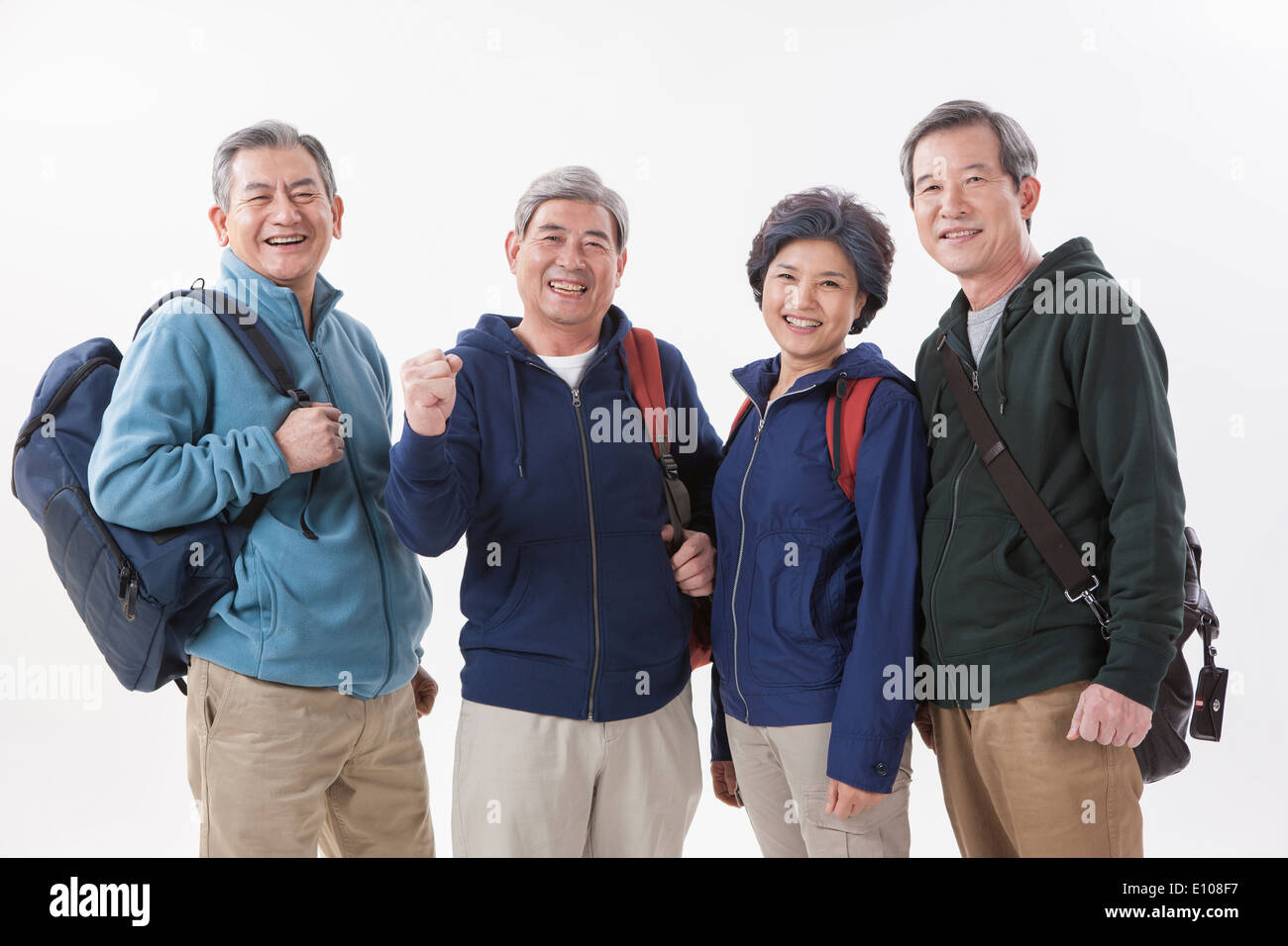 three old men and one old woman wearing a backpack Stock Photo - Alamy
