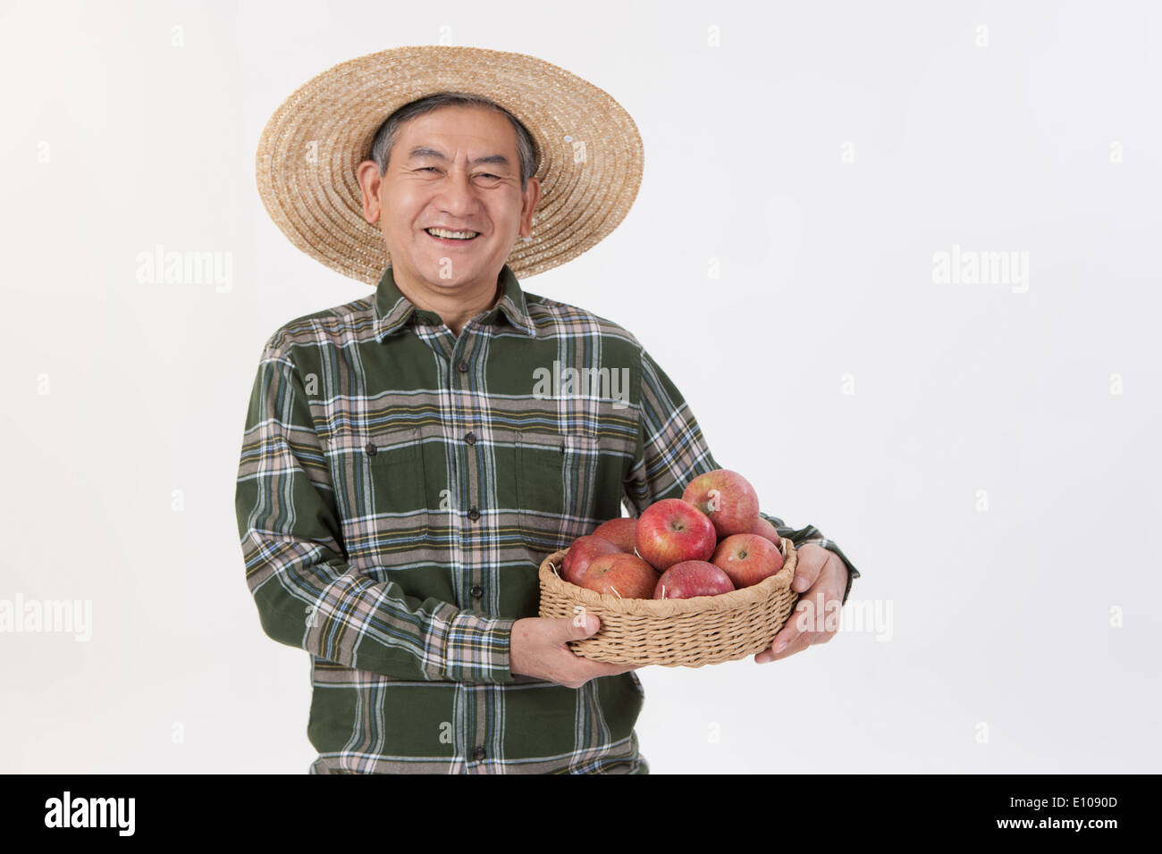 an old man holding a basket with apples Stock Photo - Alamy